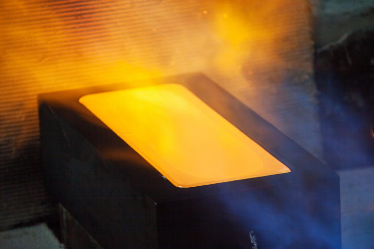Gold smelting at a metallurgical plant. Liquid gold pouring into bowls ...