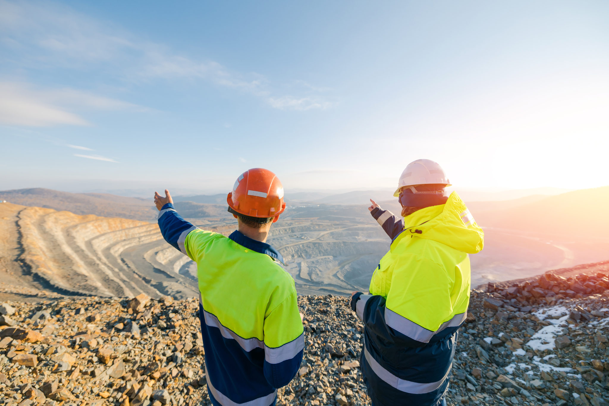Mining Engineers worker on Open Pit Quarry overlooking ore mine, back ...