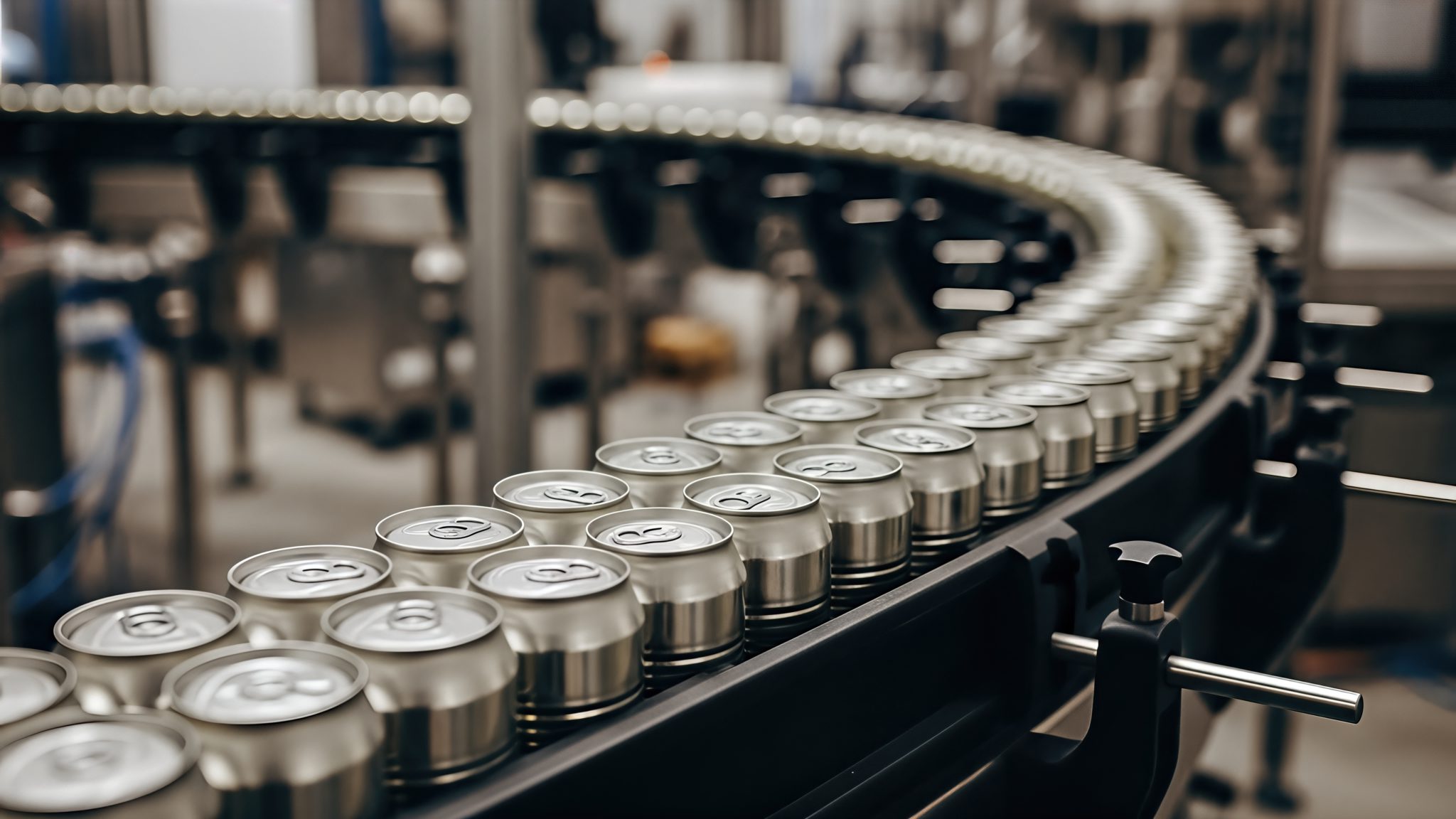 Industrial beverage production line featuring aluminum cans on conveyor ...