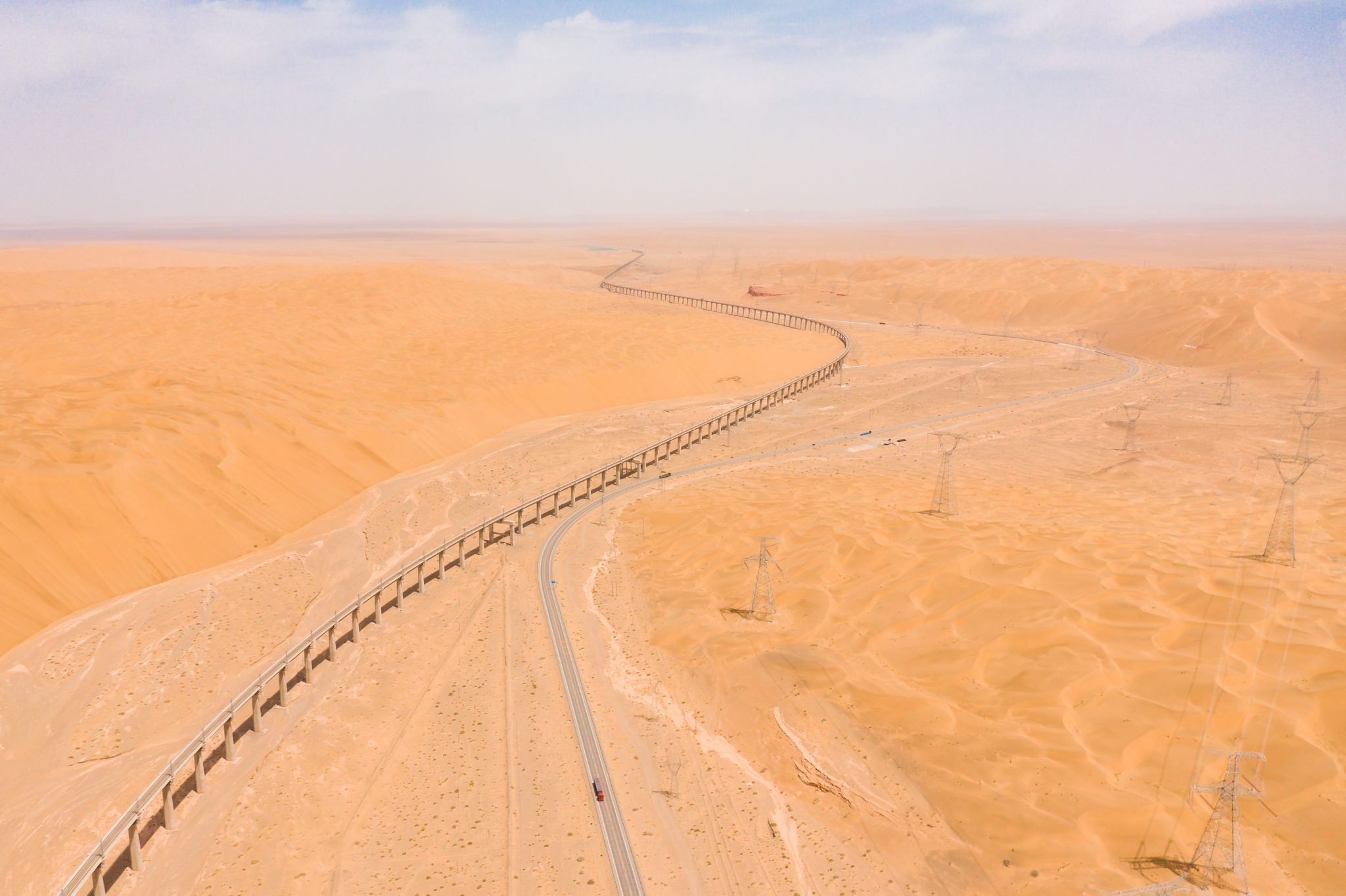 aerial view of road and railway in the desert - MINING.COM