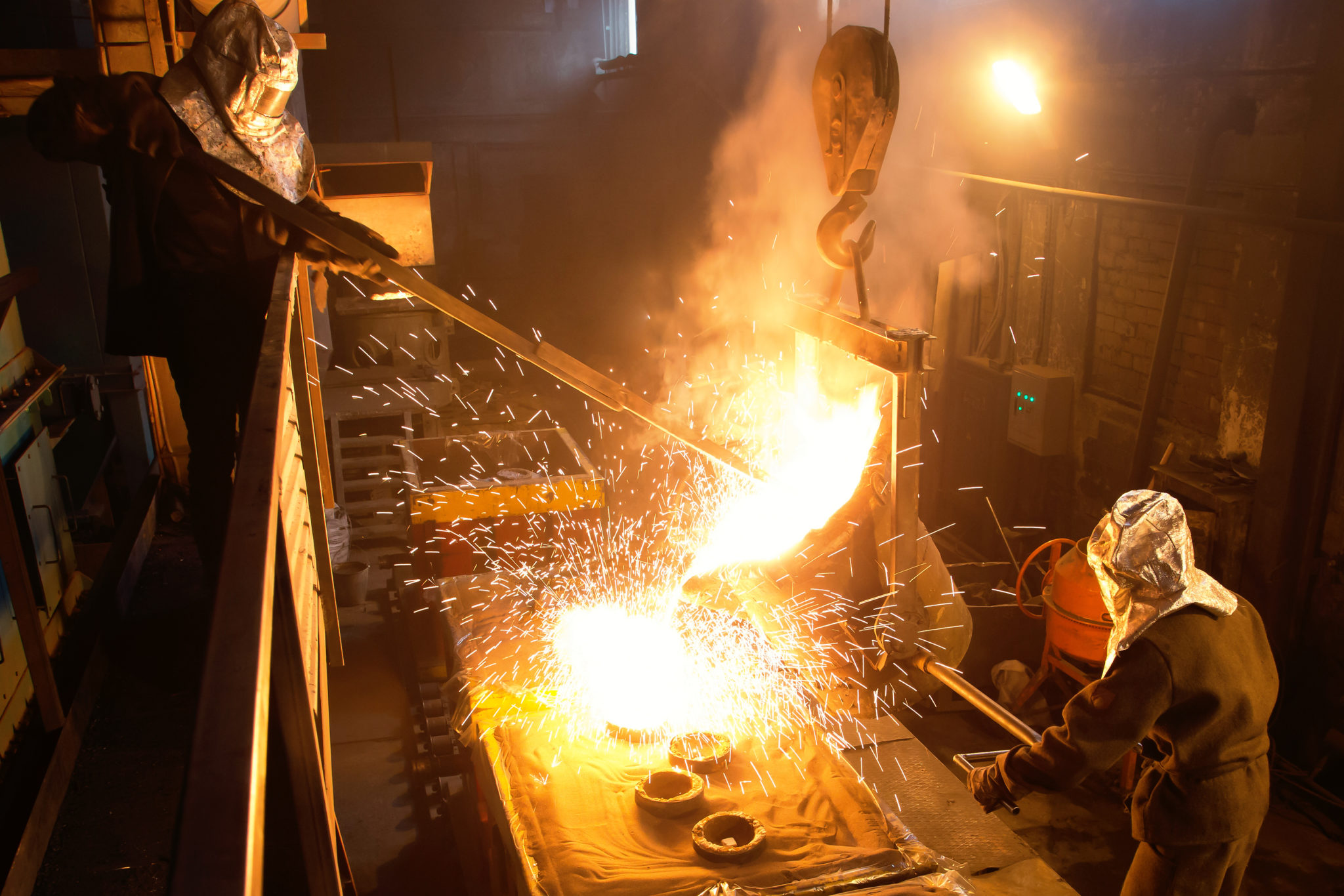 Workers operates at the metallurgical plant. Melting Iron in the ...