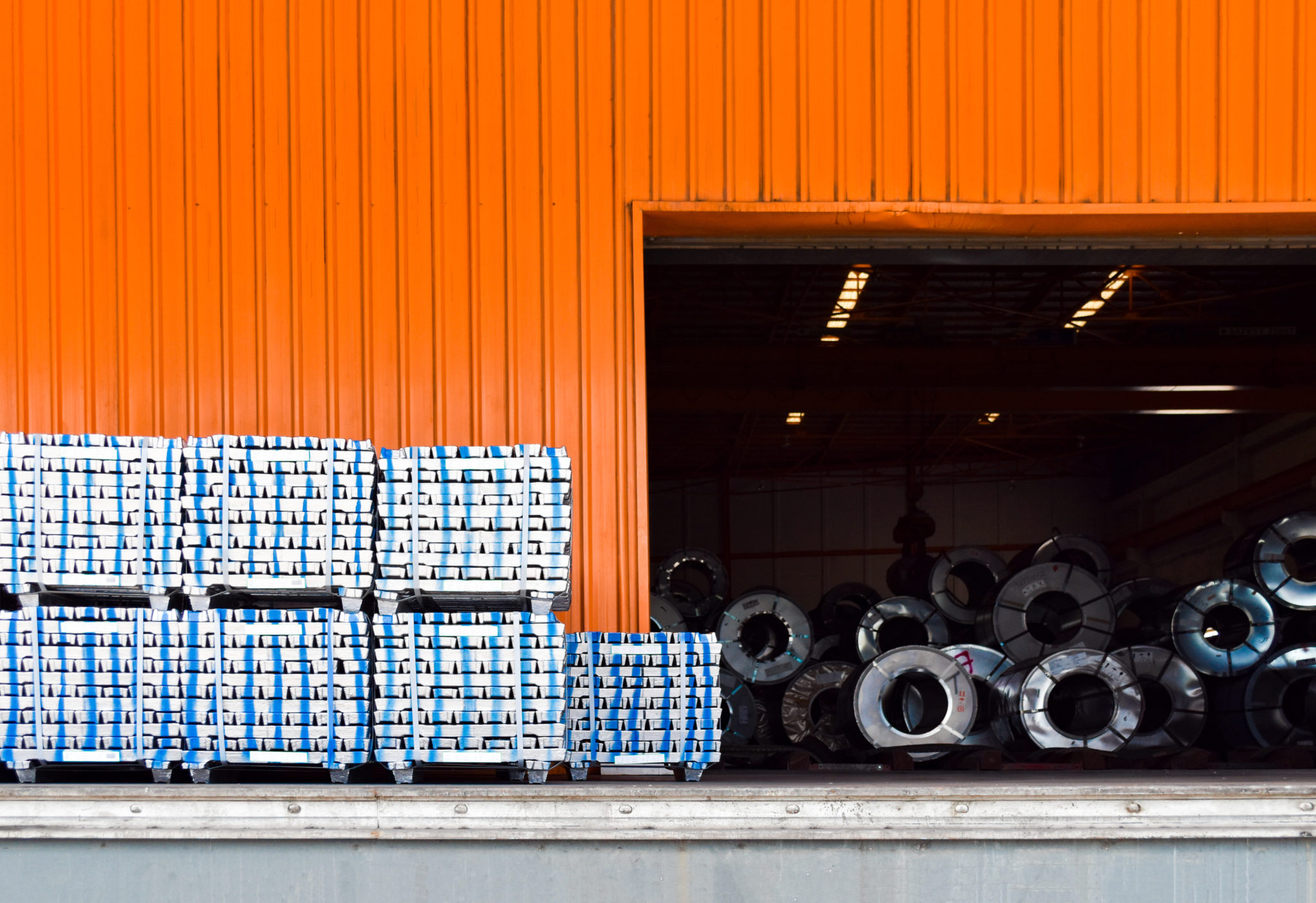 High Angle View of Bundled Aluminum Ingots on Warehouse Dock - MINING.COM